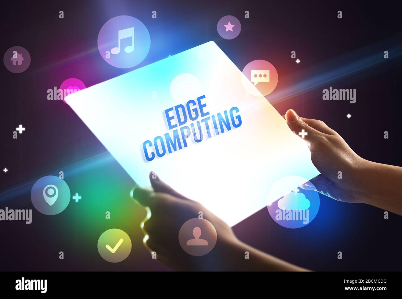 Holding futuristic tablet with EDGE COMPUTING inscription, new ...