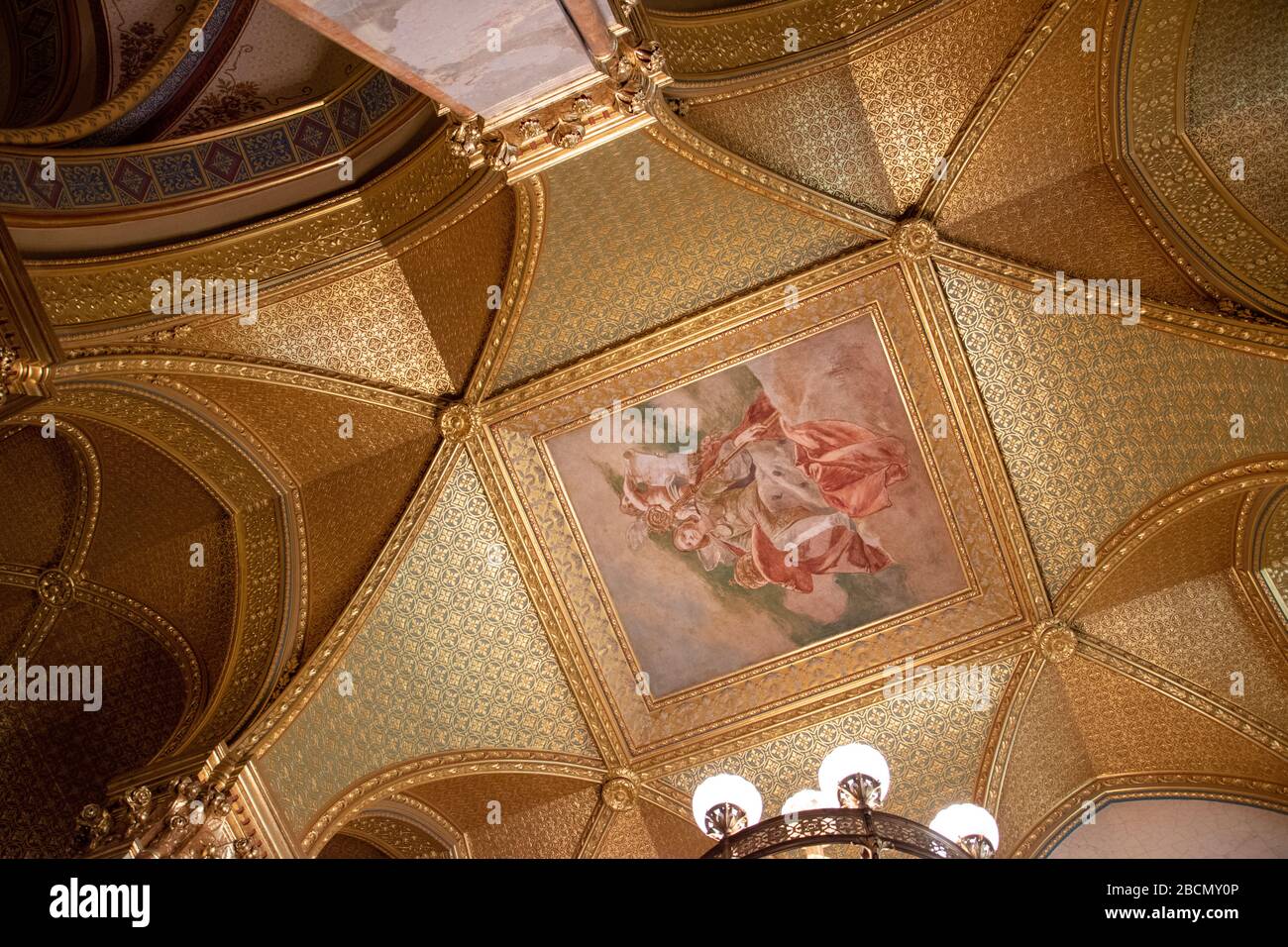 The golden gilded ceiling in the staircase of the Parliament building ...