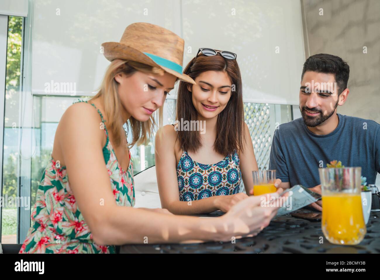 Group three tourist friends planning hi-res stock photography and ...