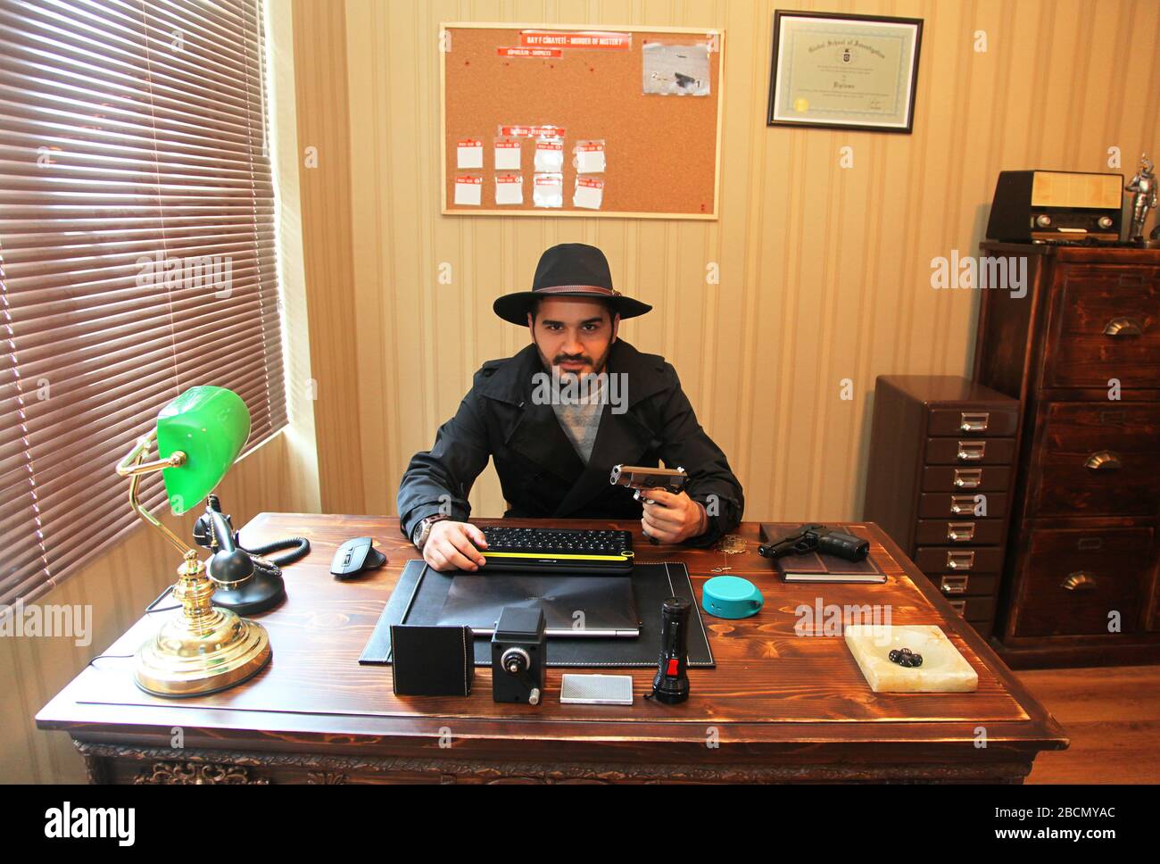 ISTANBUL, TURKEY - MAY 15: Turkish private detective working his desk ...