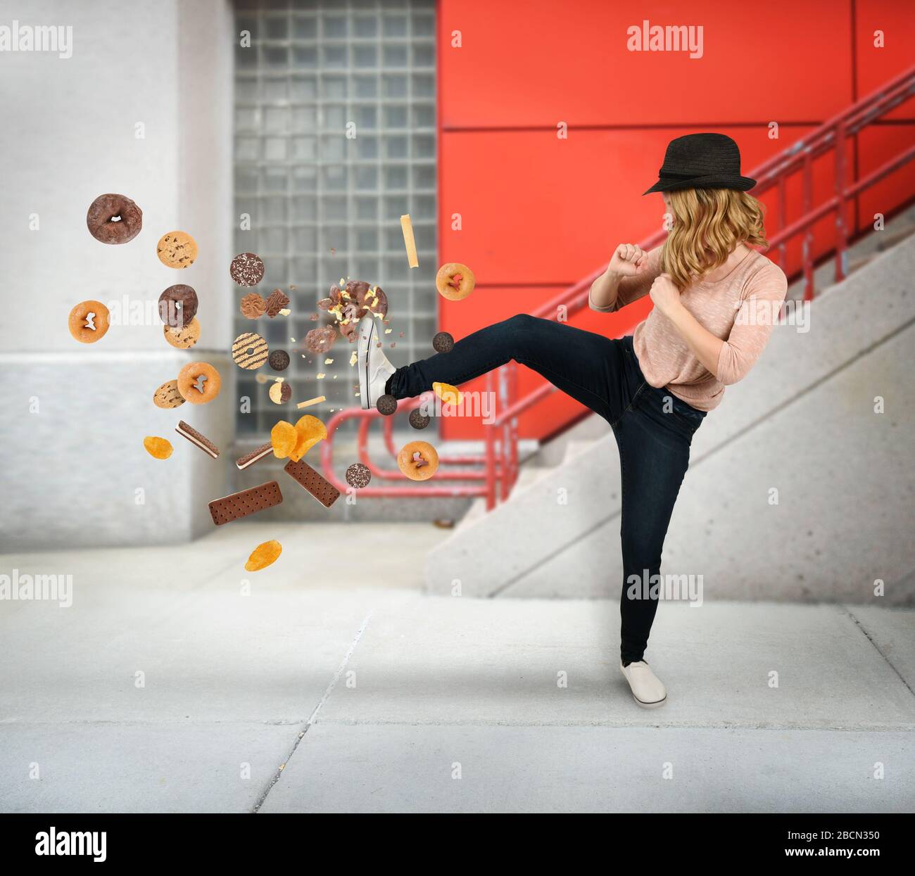 A young woman is kicking donuts with an assortment of junk food. There ...