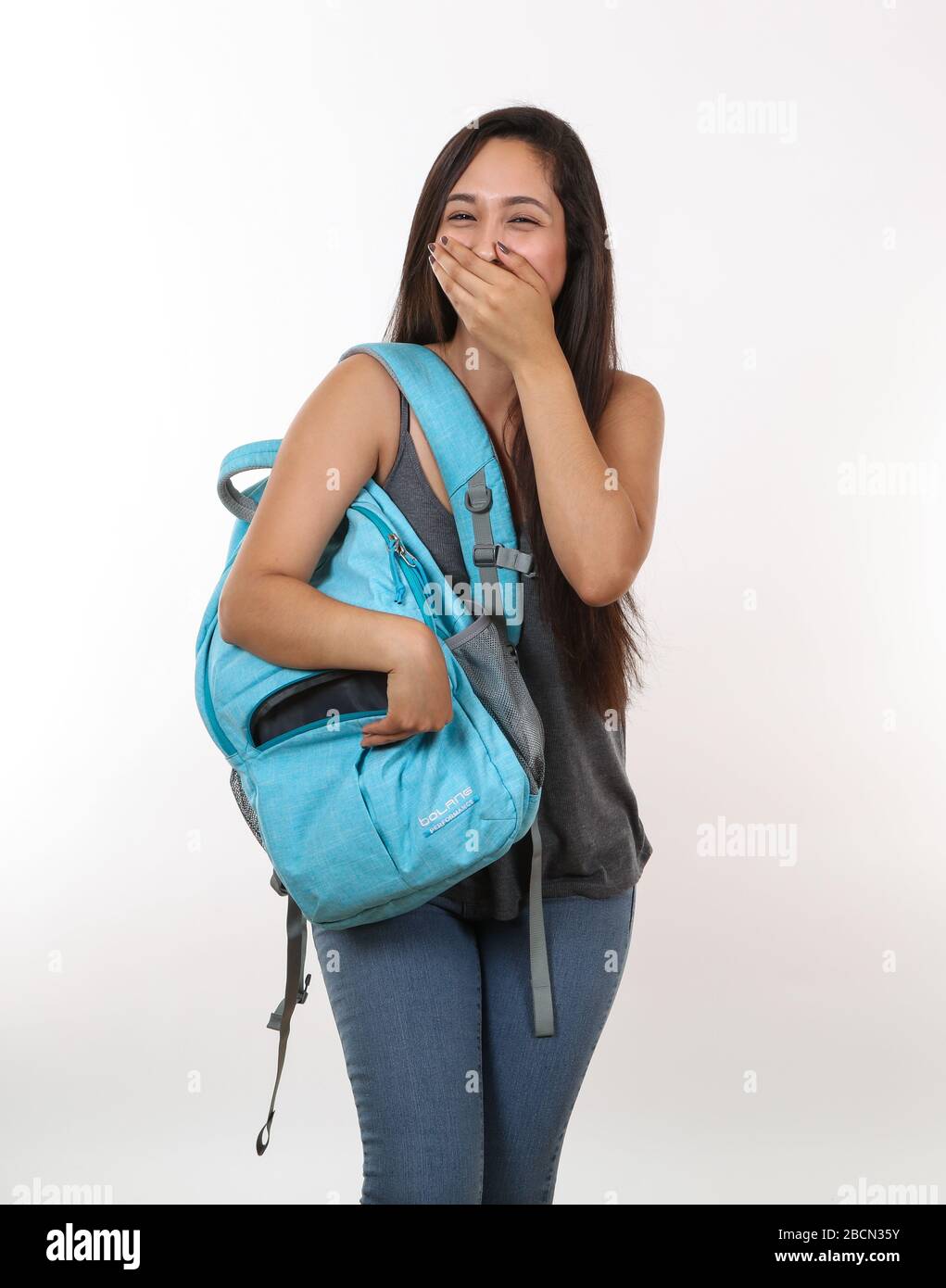 A young student laughs as she reaches for her backpack Stock Photo - Alamy