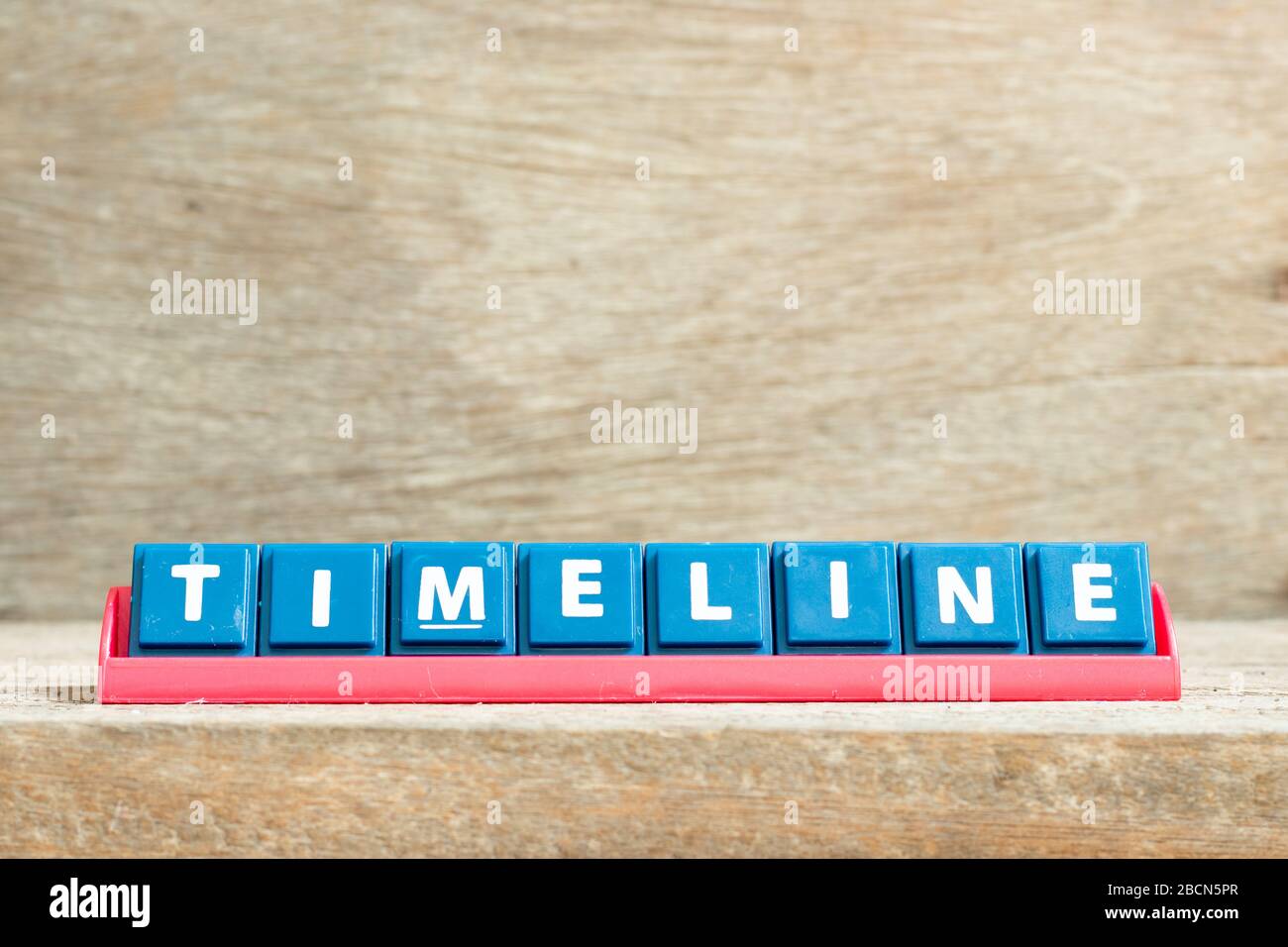 Tile letter on red rack in word timeline on wood background Stock Photo ...