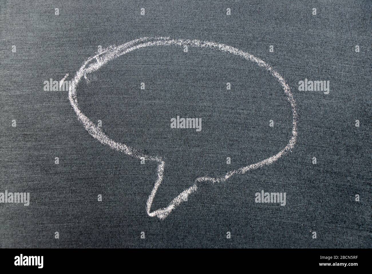 White color chalk hand drawing in round bubble speech shape with blank ...