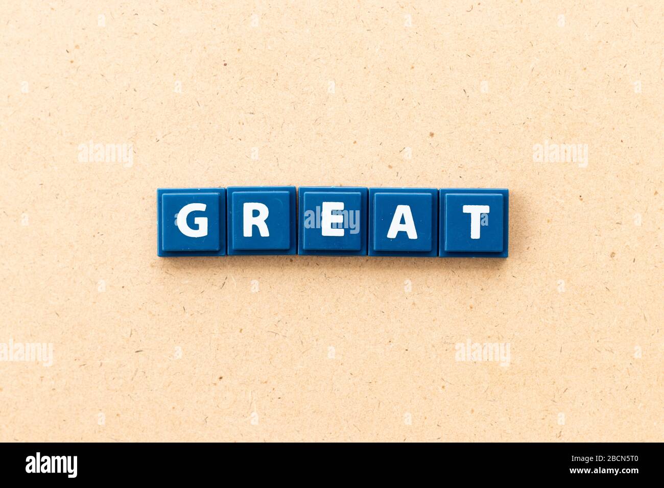 Tile letter in word great on wood background Stock Photo - Alamy