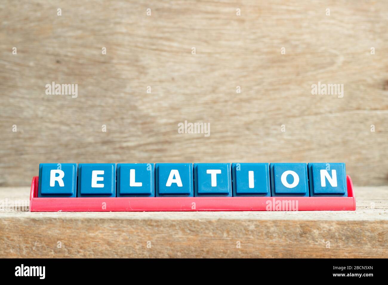 Tile letter on red rack in word relation on wood background Stock Photo ...
