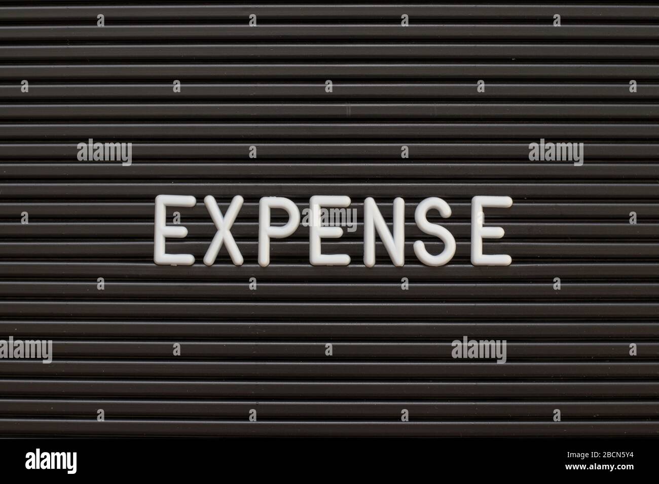 Black color felt letter board with white alphabet in word expense ...