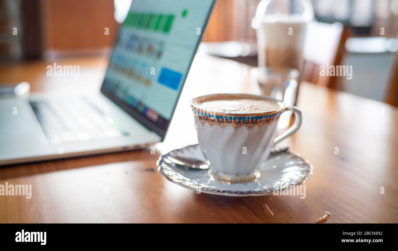 Hot aroma cappuccino coffee cup on wooden table work from home with ...