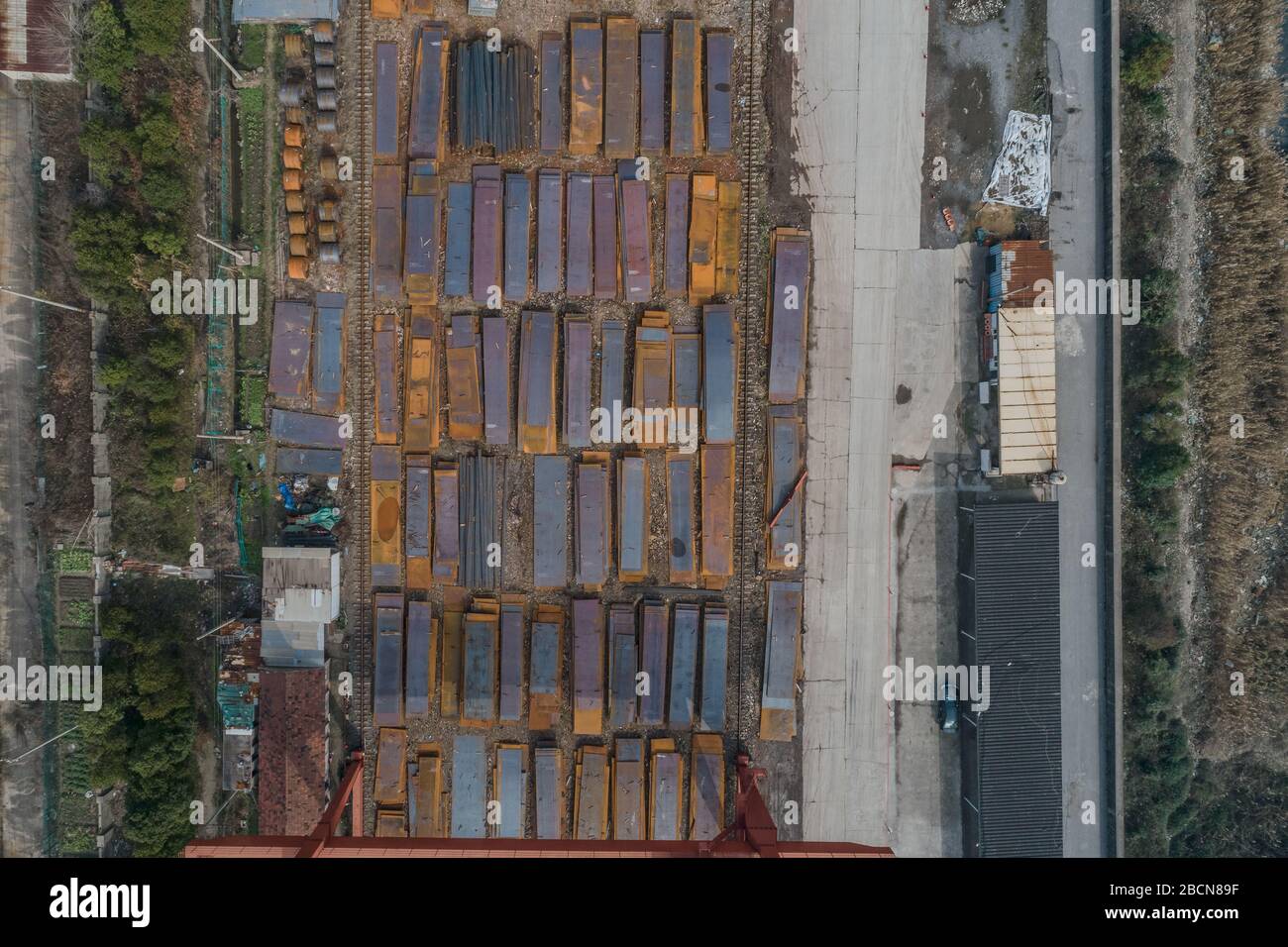 aerial view of steel plates and metal profiles stocked in a factory ...