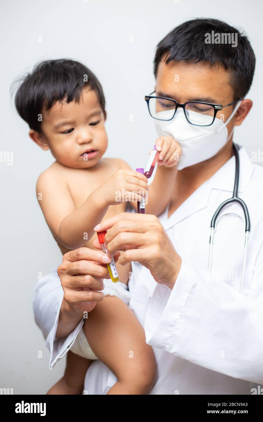 Cheerful asian pediatrician doing a medical checkup corona virus of a ...