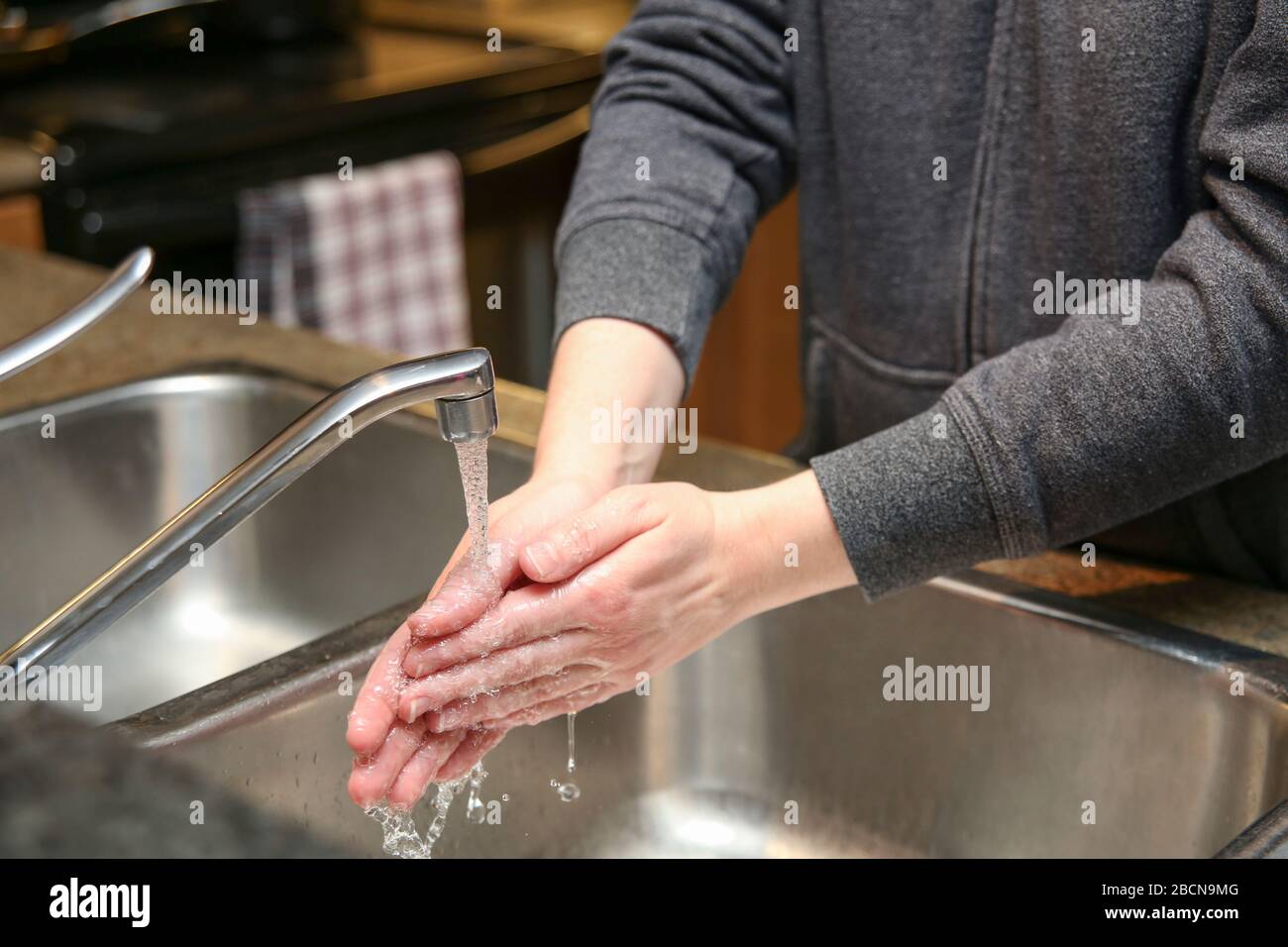 Young Woman Washing her Hands at the Kitchen. Hygine Care, Sick ...