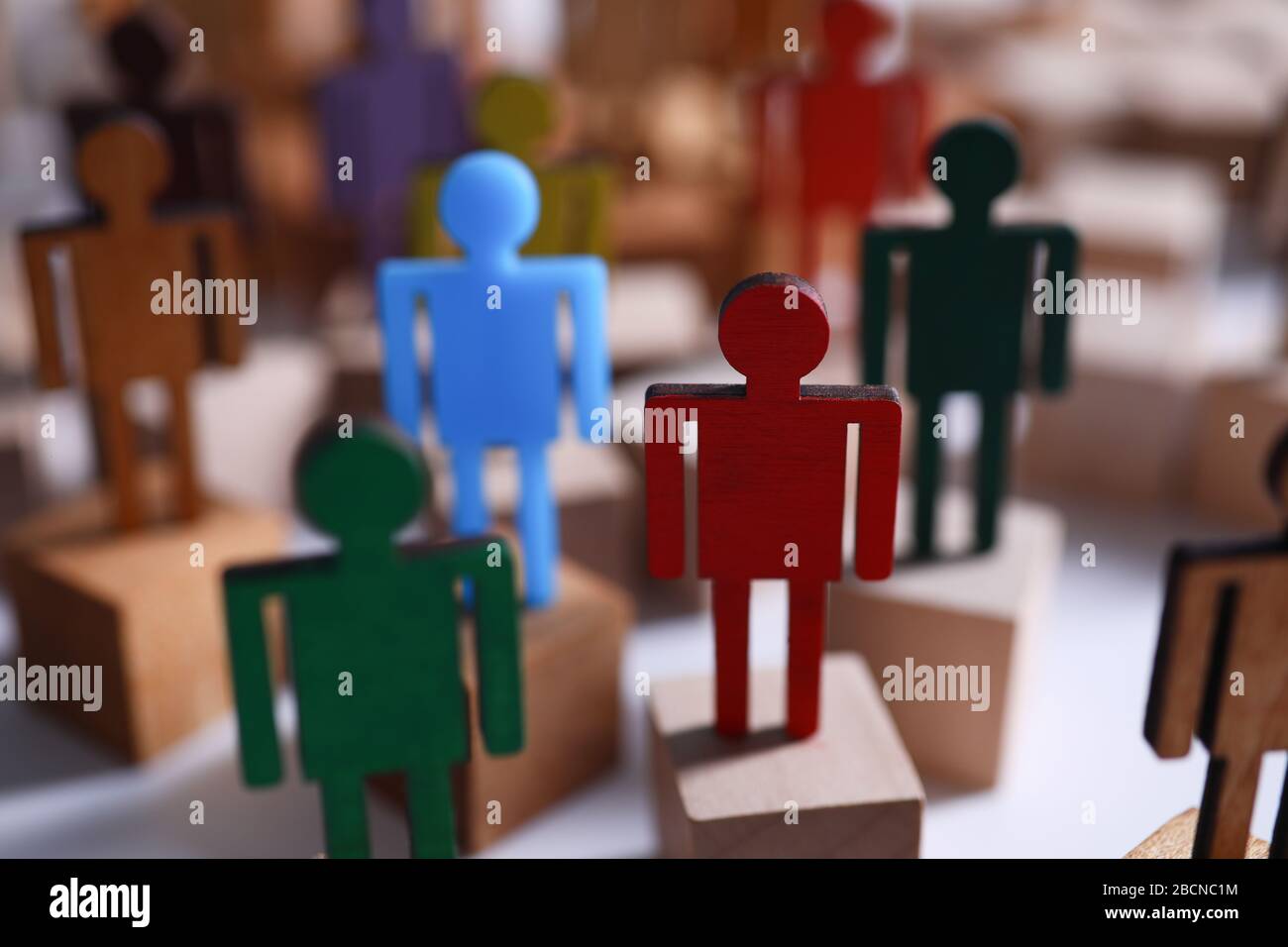 Colored wooden figures in form man stand table Stock Photo - Alamy