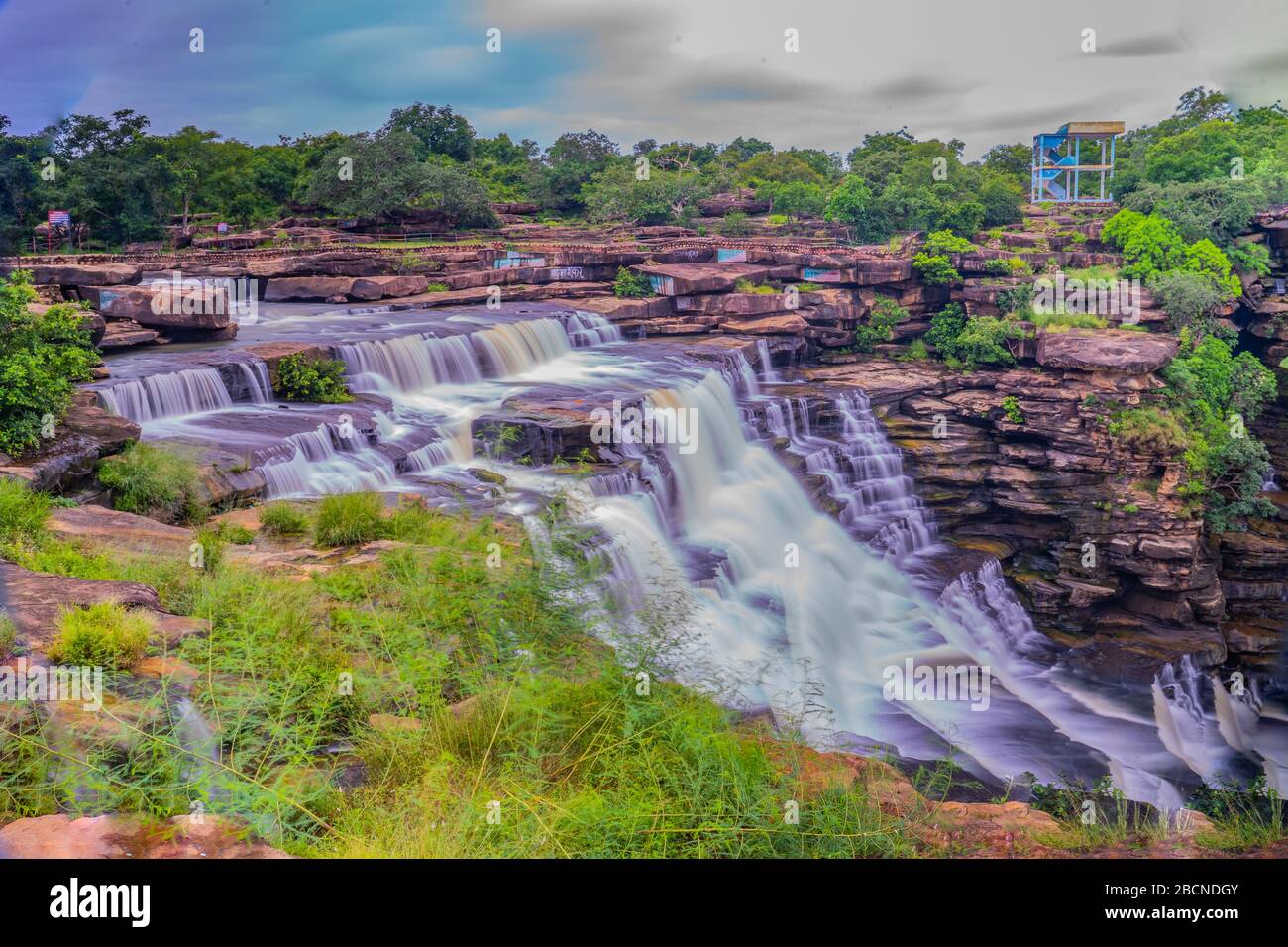 A fall of water is an area where water flows over a vertical drop or a ...