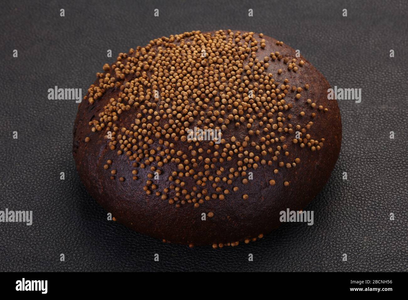 Black tasty bread with cilantro seeds Stock Photo - Alamy