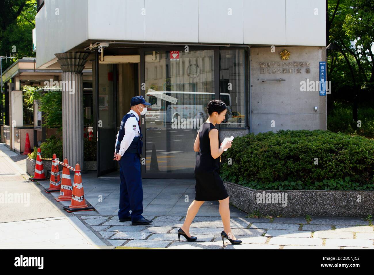 A police officer in front of Hibiya Park Police Box which is located in ...