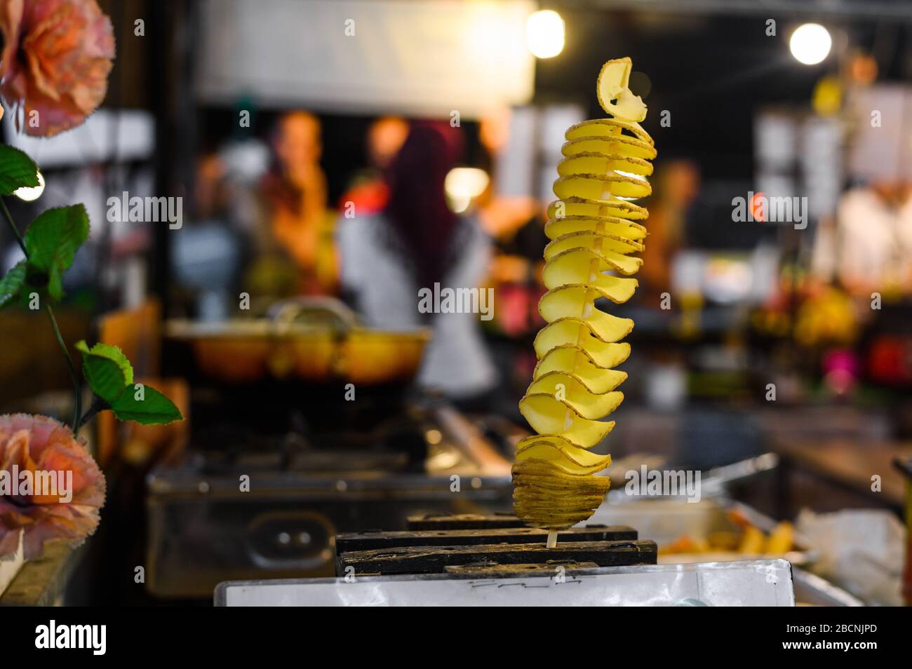 Fried potato springs. Street food on a stick at Thailand night market ...