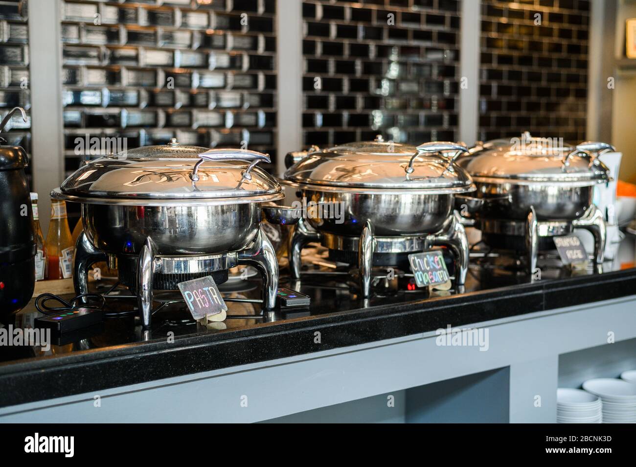 Buffet Table with Row of Food Service Steam Pans Stock Photo - Alamy
