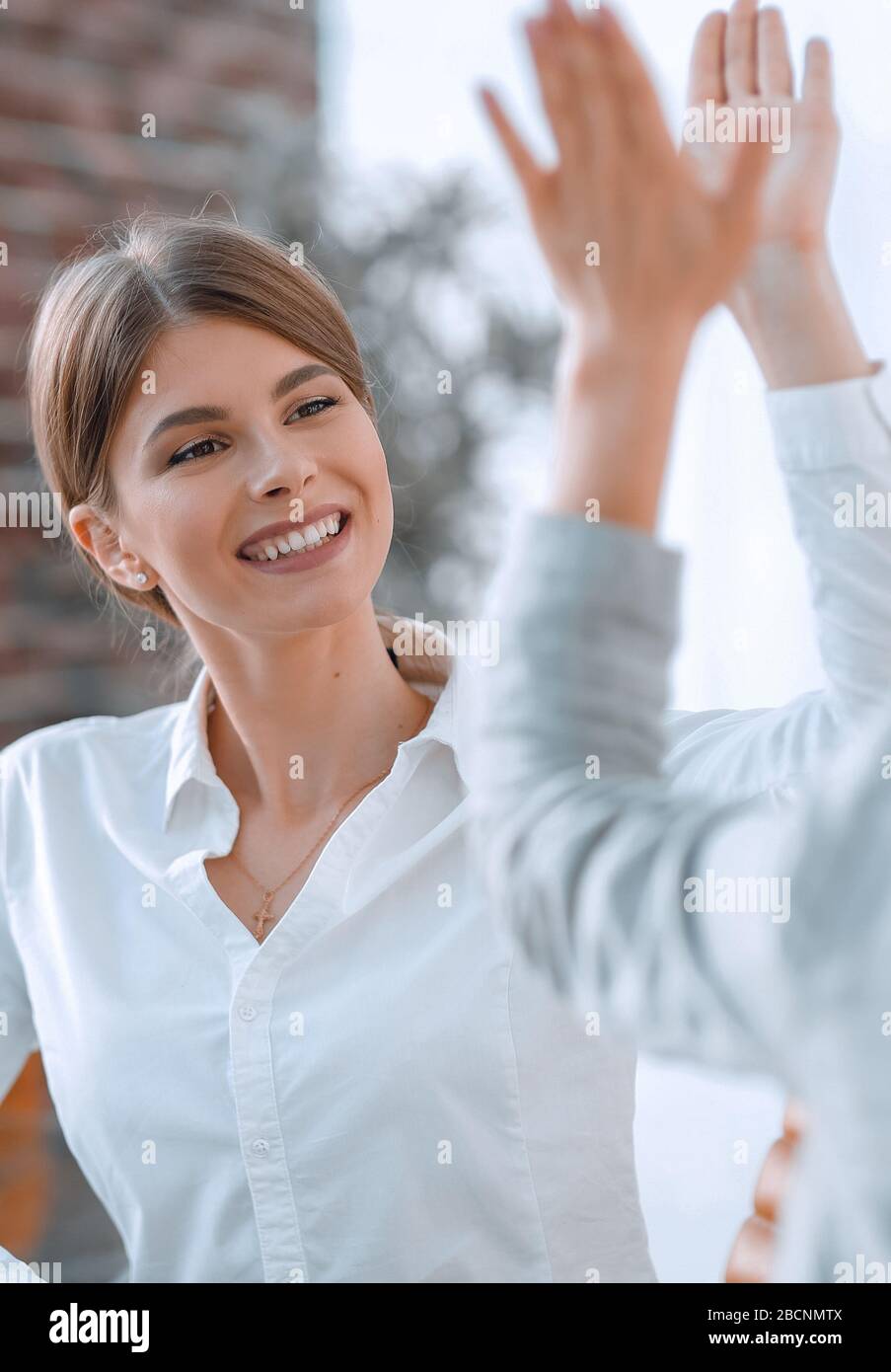 members of the business team giving each other a high five Stock Photo ...