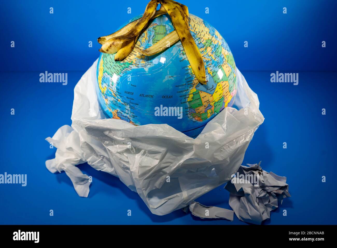 Grocery Plastic with earth inside with blue background. Earth is being ...