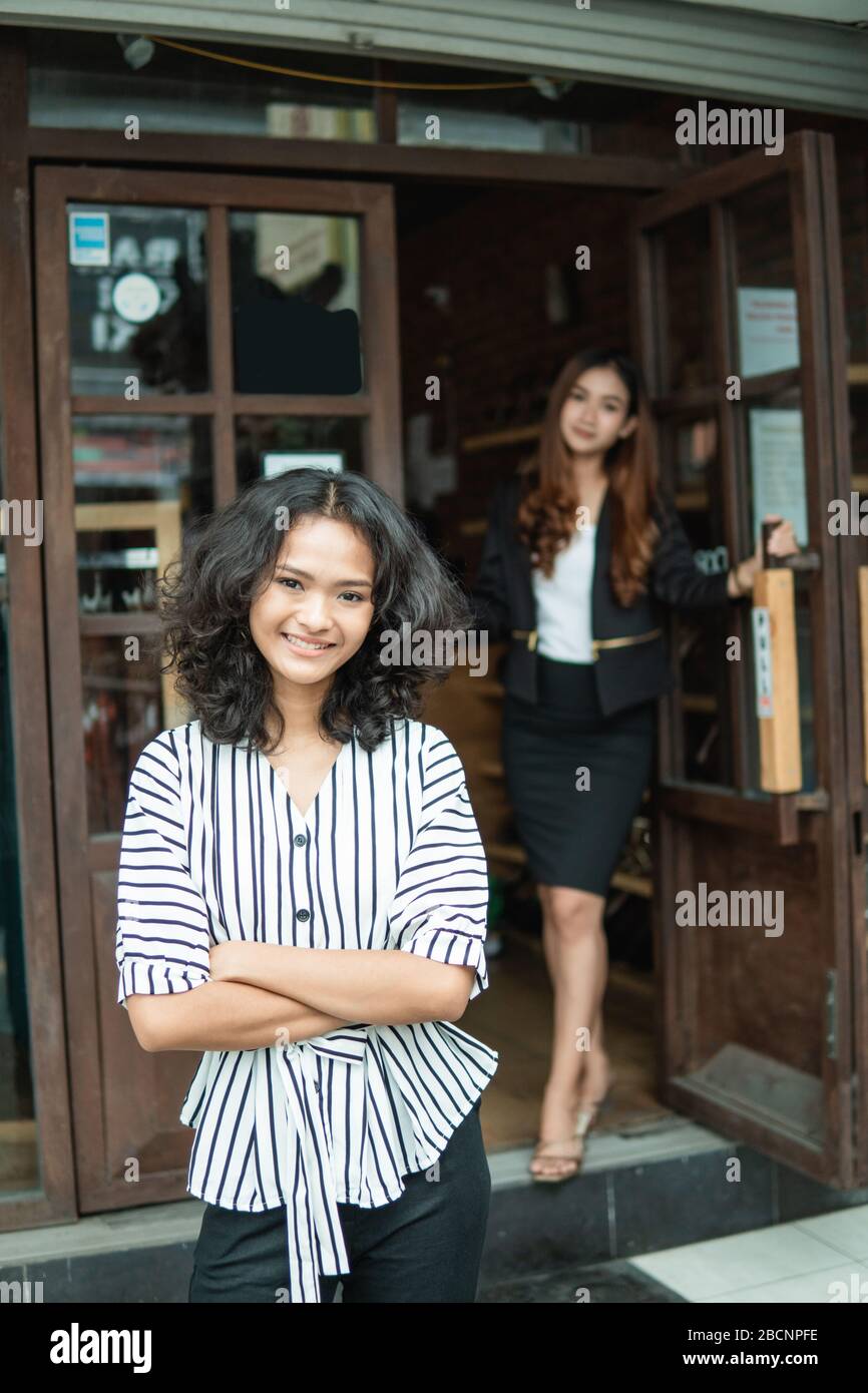 beautiful young asian fashion shop owner at her boutique standing ...