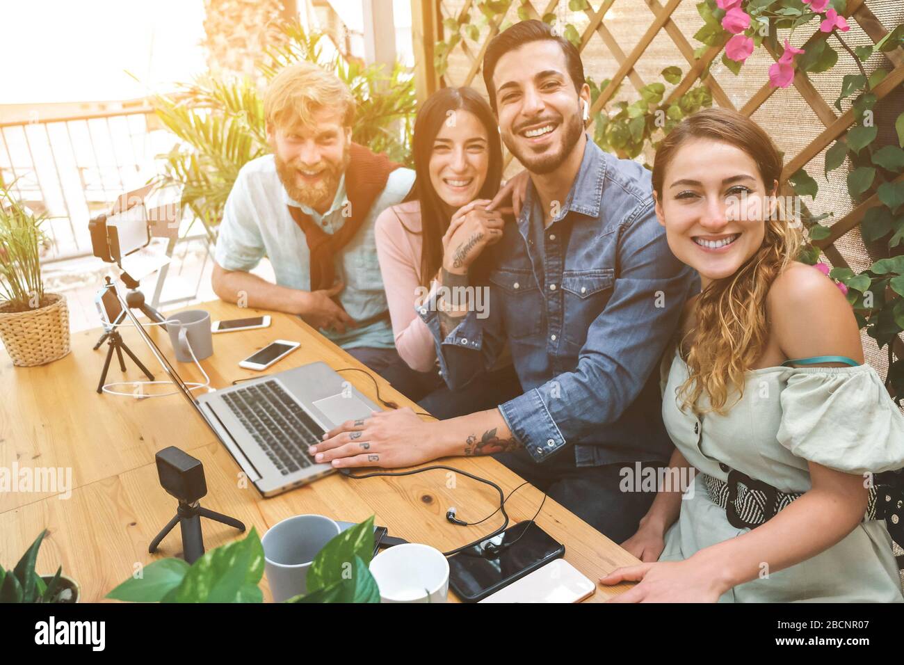 Young people streaming online using laptop, smartphone camera and ...