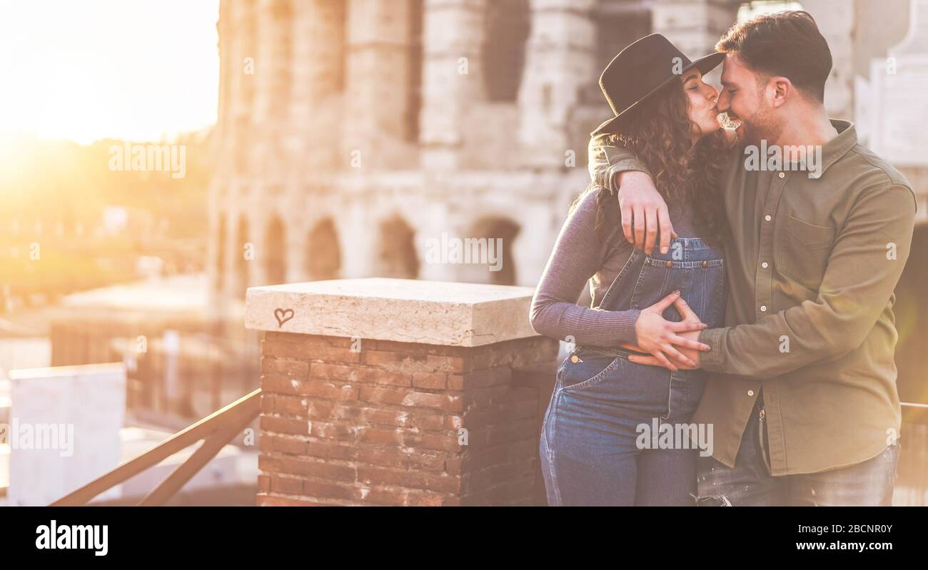 Young couple having tender moments in Rome with Colosseum as background ...