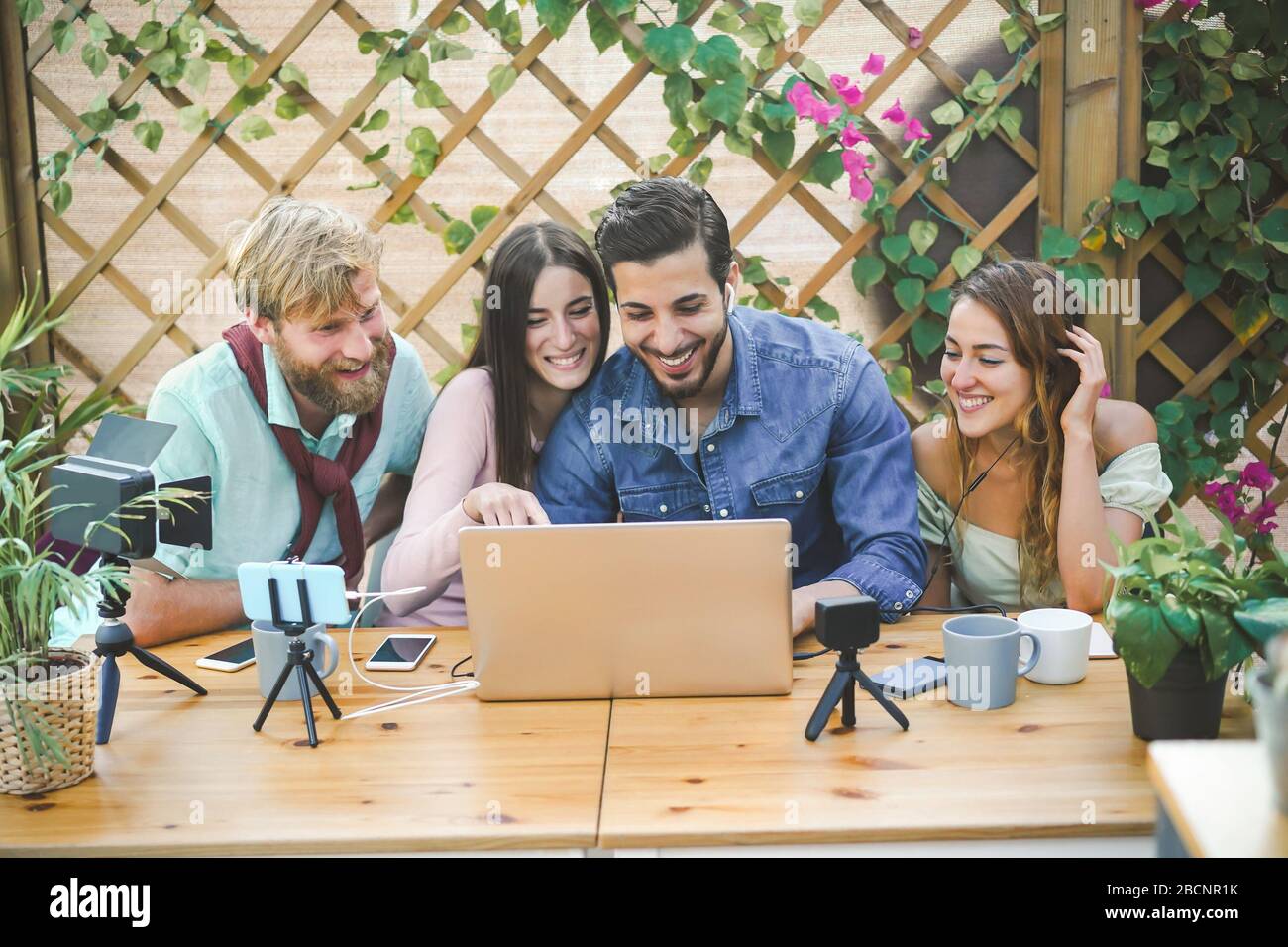 Young people streaming online using laptop, smartphone camera and ...