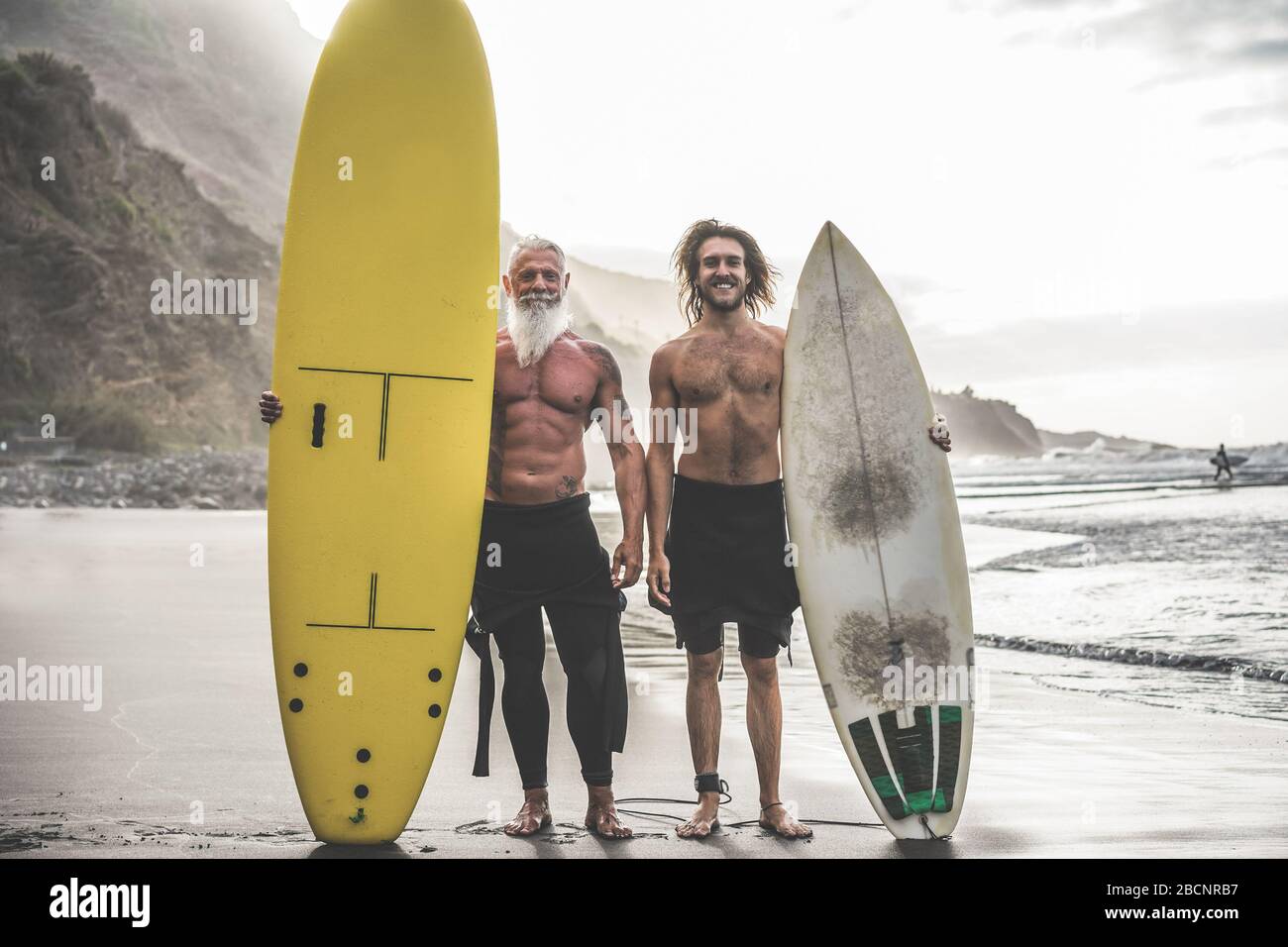 Multigeneration friends going to surf on tropical beach - Family people ...