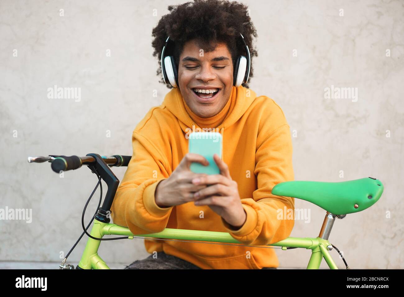Happy african millennial guy listening music playlist with smartphone ...