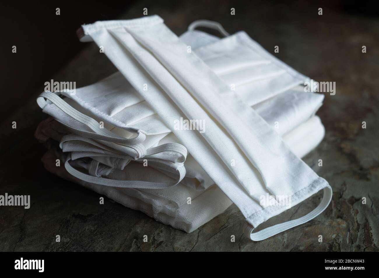 Stack of protectiv antivirus masks made by their hands from white ...