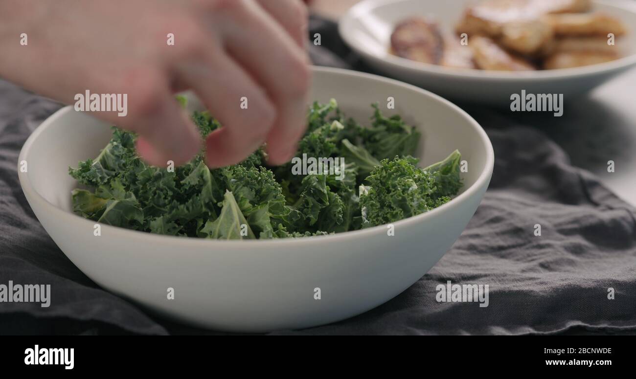 man hands put kale leaves in white bowl Stock Photo - Alamy