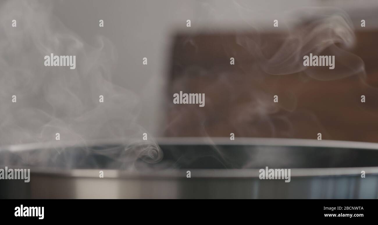 steam rising from pan while cooking food closeup Stock Photo - Alamy