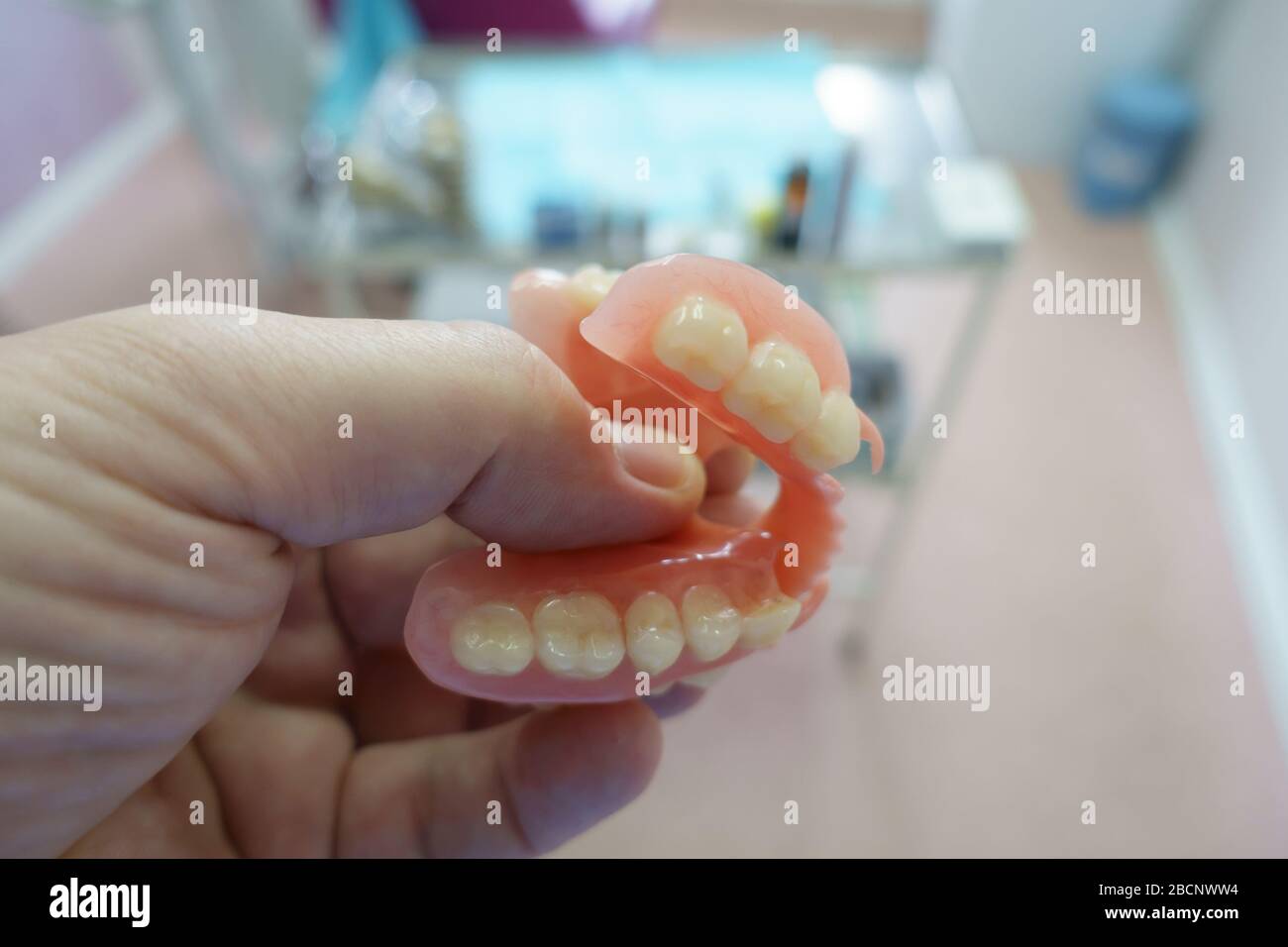 removable denture in the hands of a doctor in a dental office Stock ...