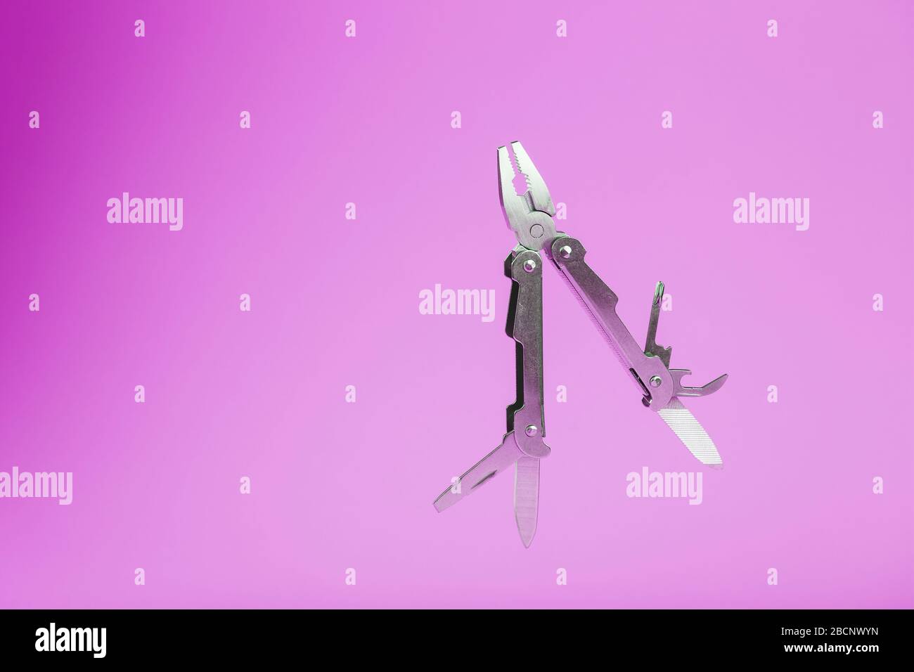 Multitool is a multi-functional tool on a pink background. The concept ...