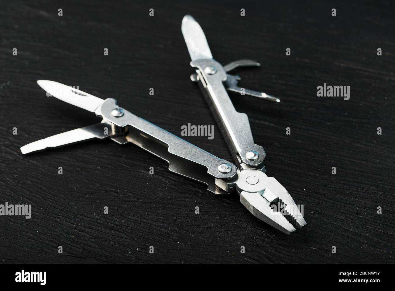 Multitool is a multi-functional tool on a black background. The concept ...