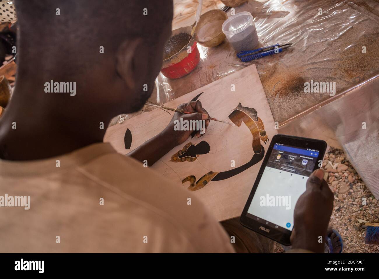 Local artist is painting a traditional artwork Stock Photo - Alamy