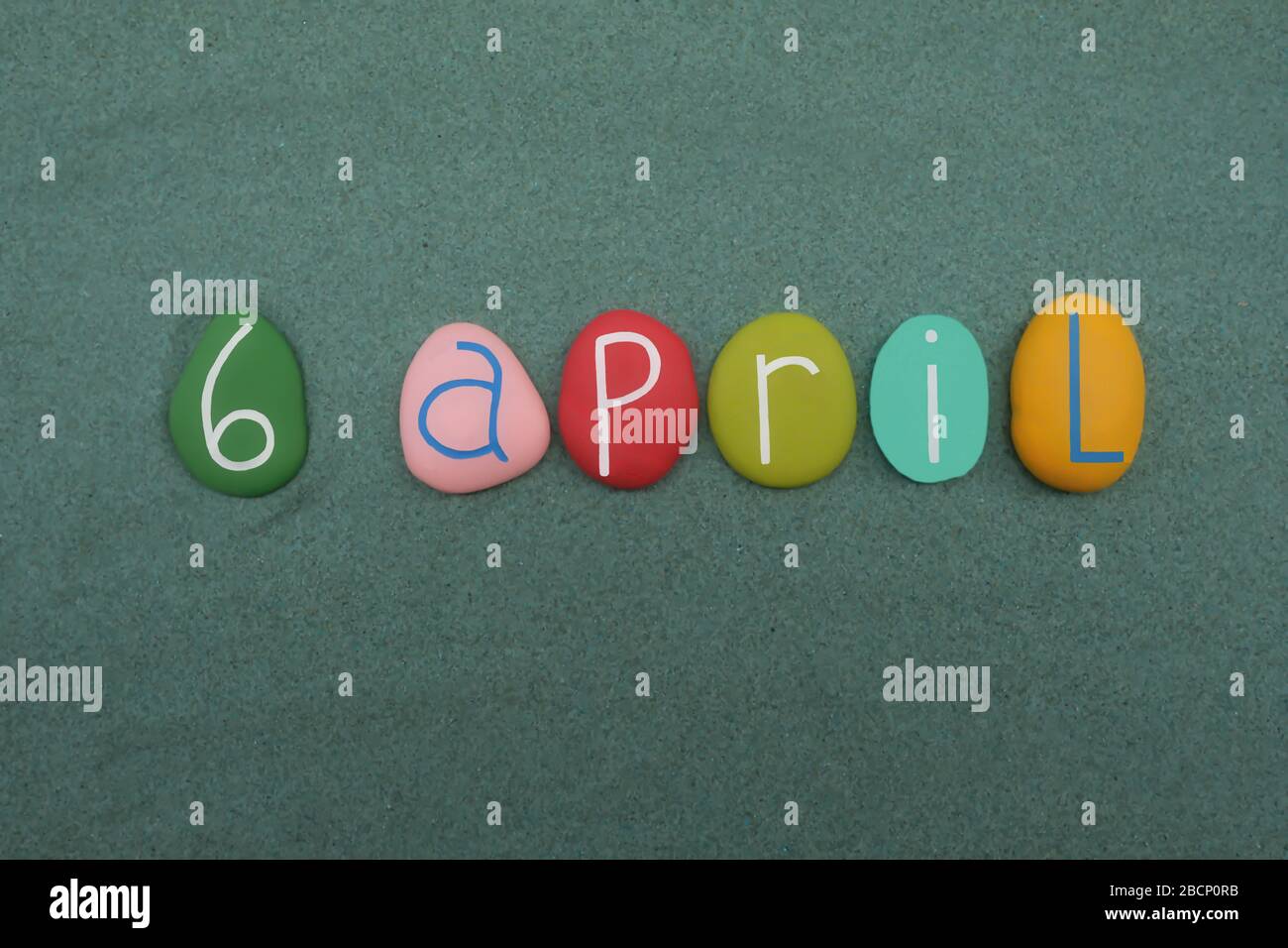 6 April, calendar date composed with colored and carved stones over ...