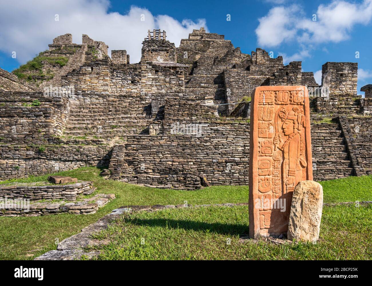 Stela (replica) in front of temples at Acropolis, Maya ruins at Tonina ...