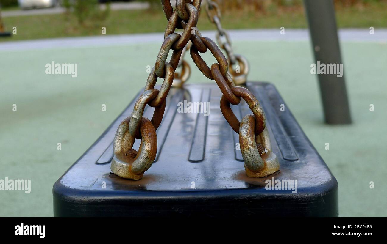 Outdoor swing, chains holding the seat. Children's playground in Swing ...