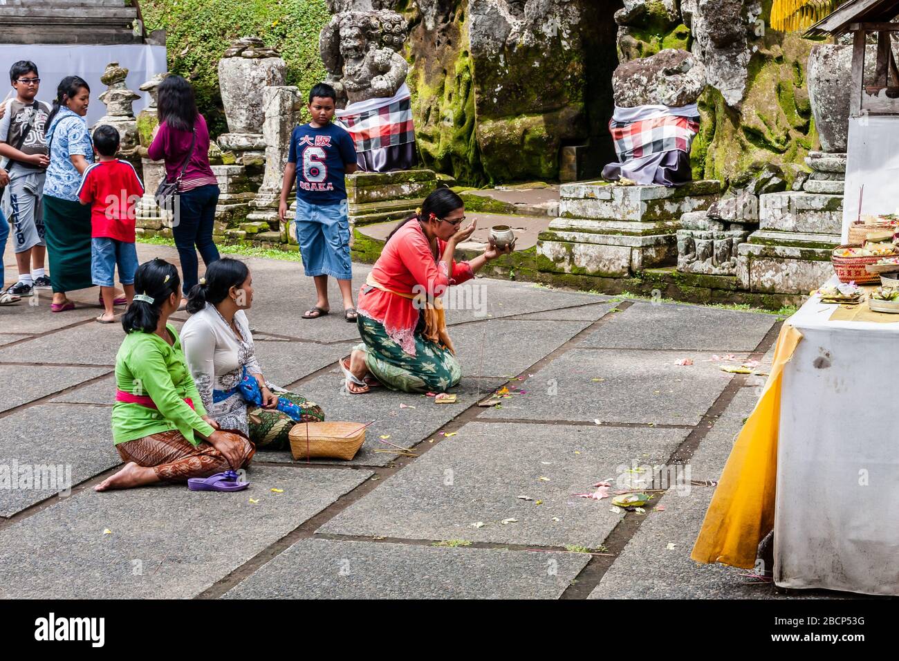 Balinese women praying near the ‘Elephant Cave’ at the Goa Gajah Temple ...