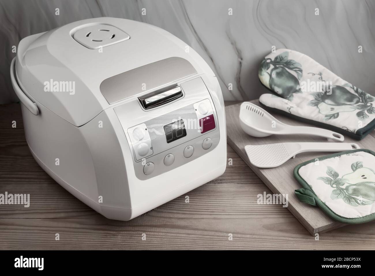 Modern electric multi-cooker and a set of kitchen accessories Stock ...