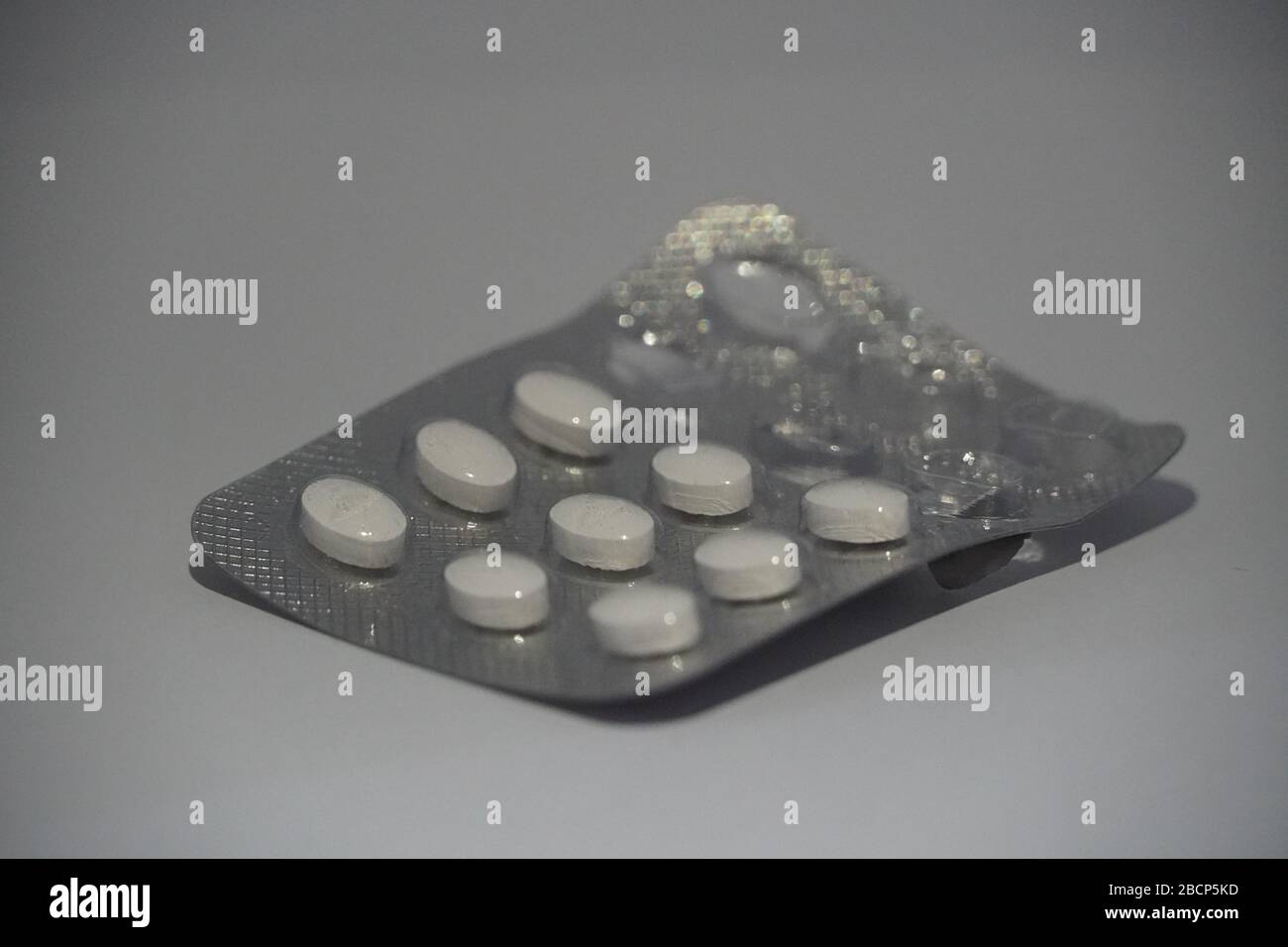 Used packs of pills on white medical table. It is isolated on white ...