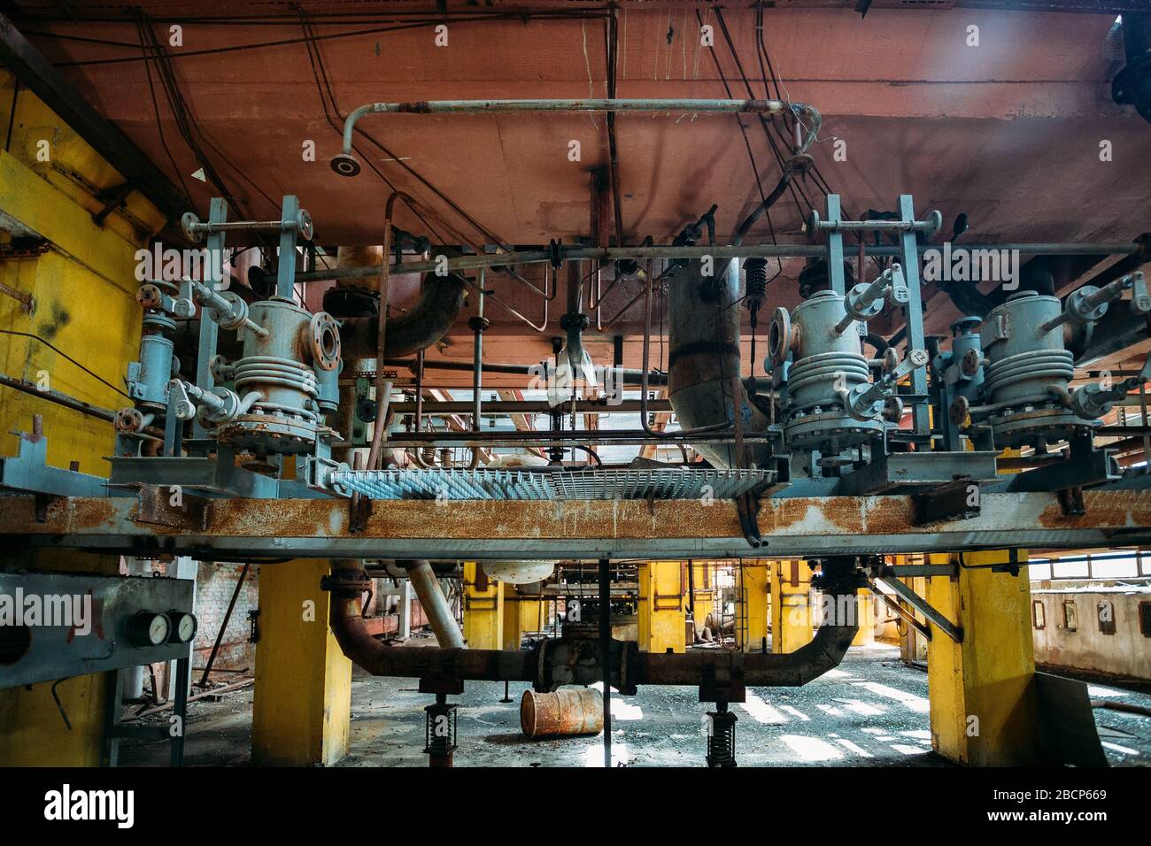 Old rusty Industrial tanks connected by pipes connected with valves in ...
