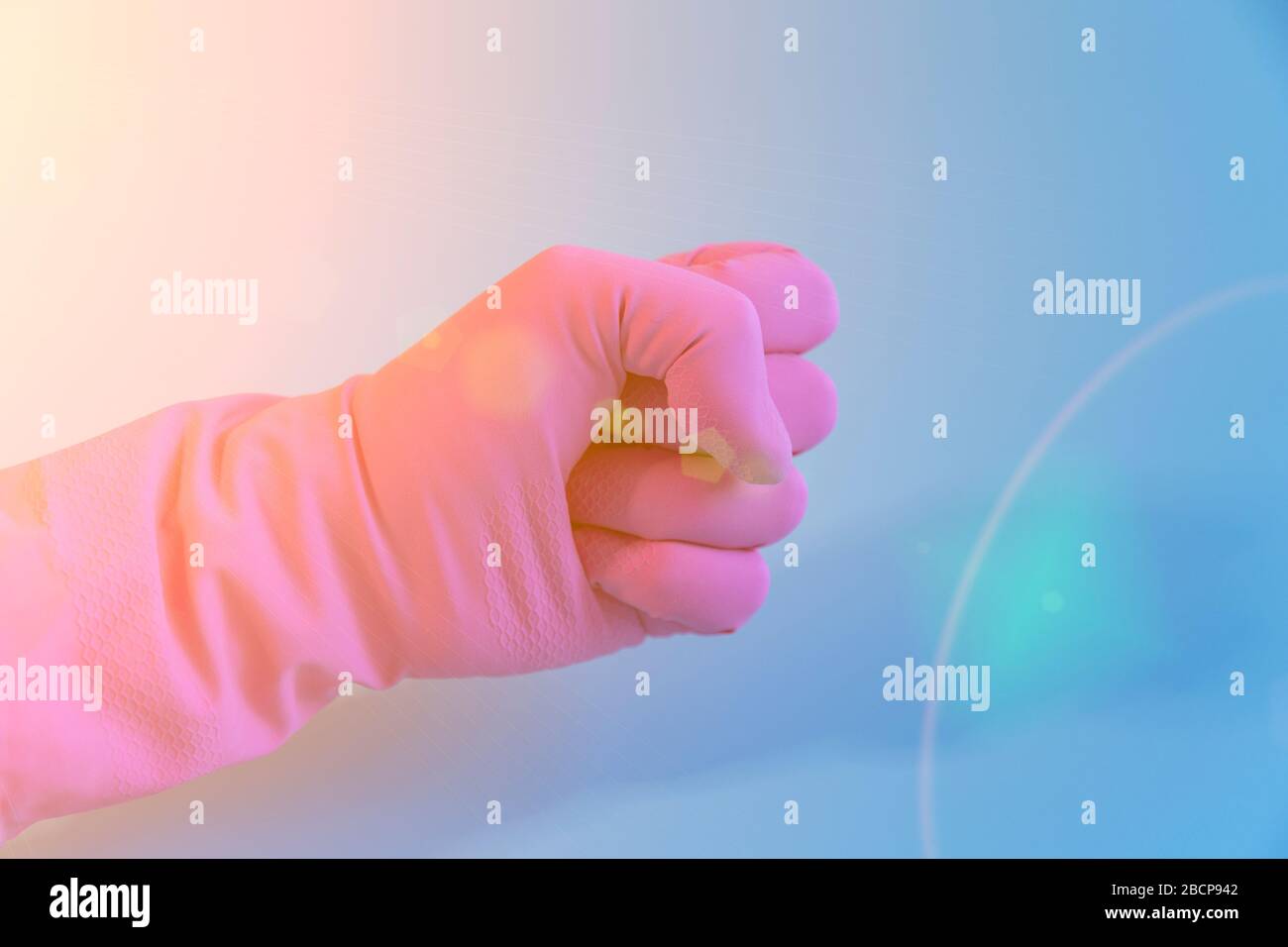Hand with cleaning glove making fist. toned Stock Photo - Alamy