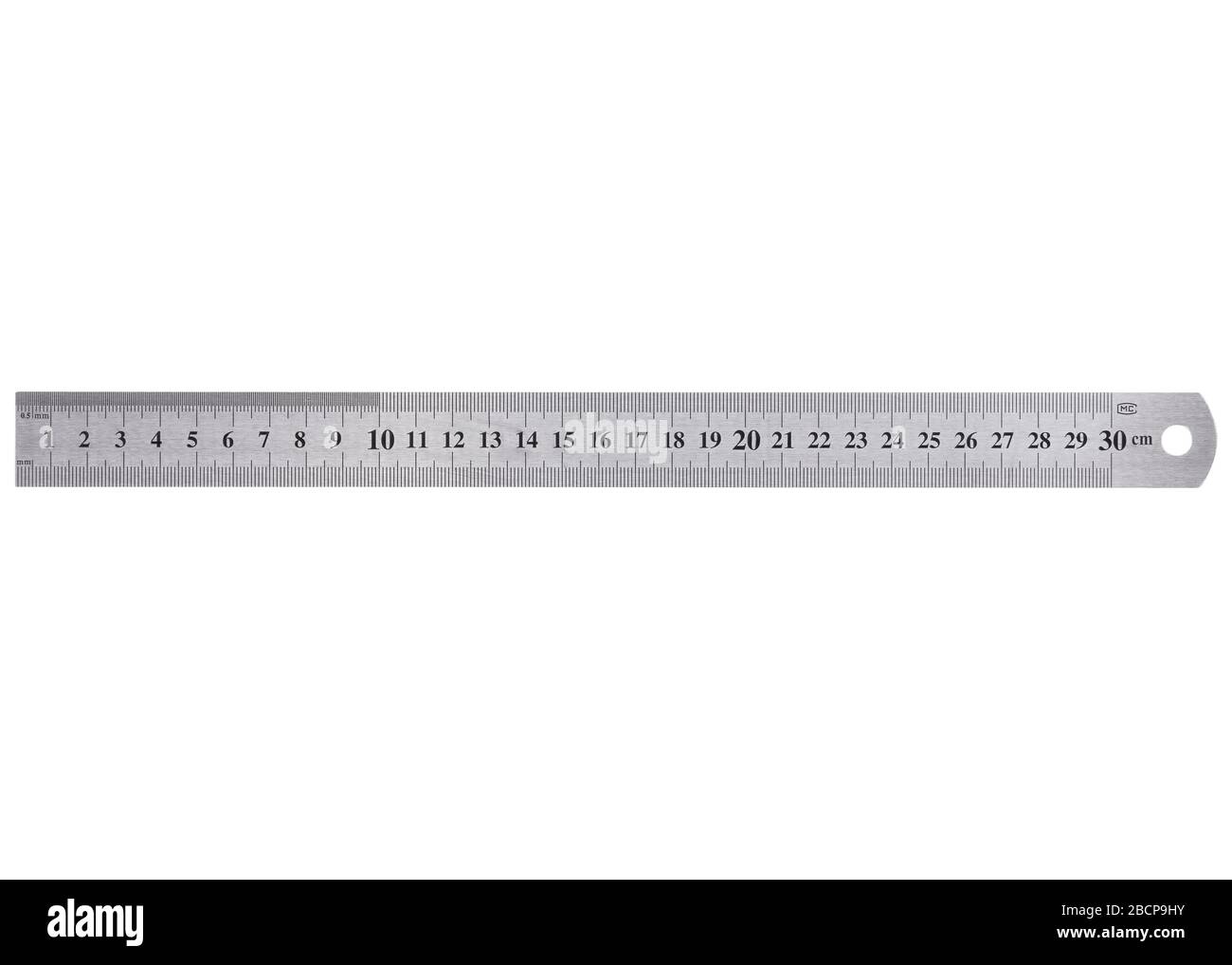 A metal ruler with a scale of up to 30 centimeters is isolated on a ...