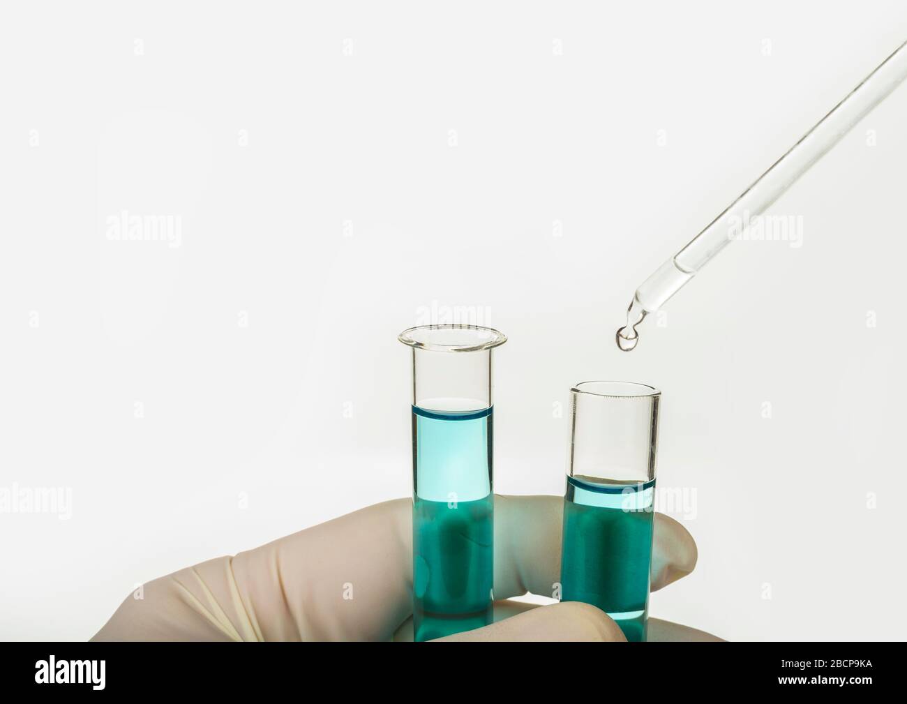 Dripping reagent into test tube with liquid sample Stock Photo - Alamy