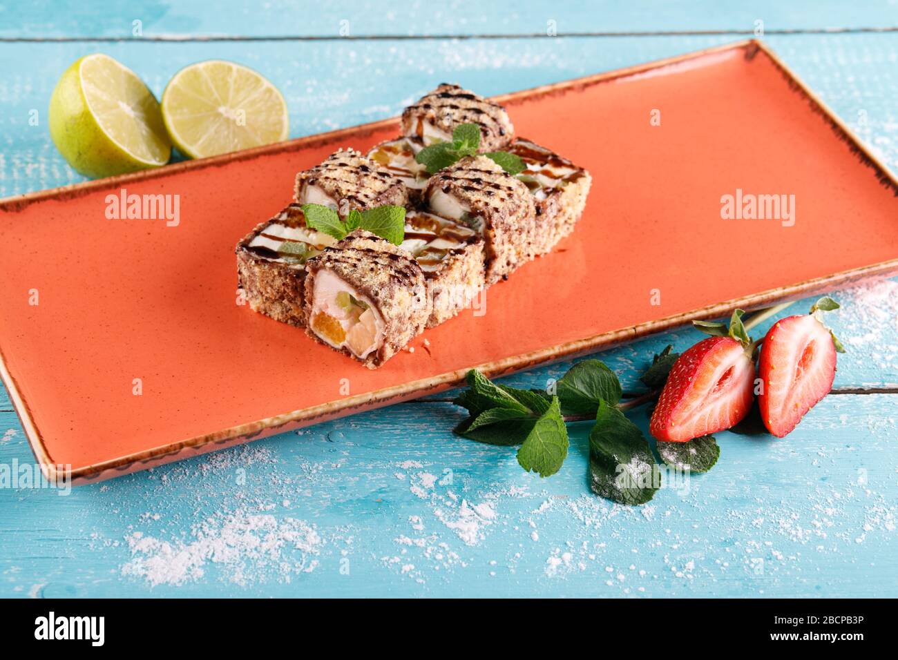 Dessert Maki sushi roll with various fruits and cream cheese inside ...