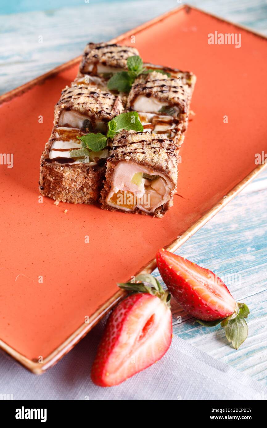 Dessert Maki sushi roll with various fruits and cream cheese inside ...