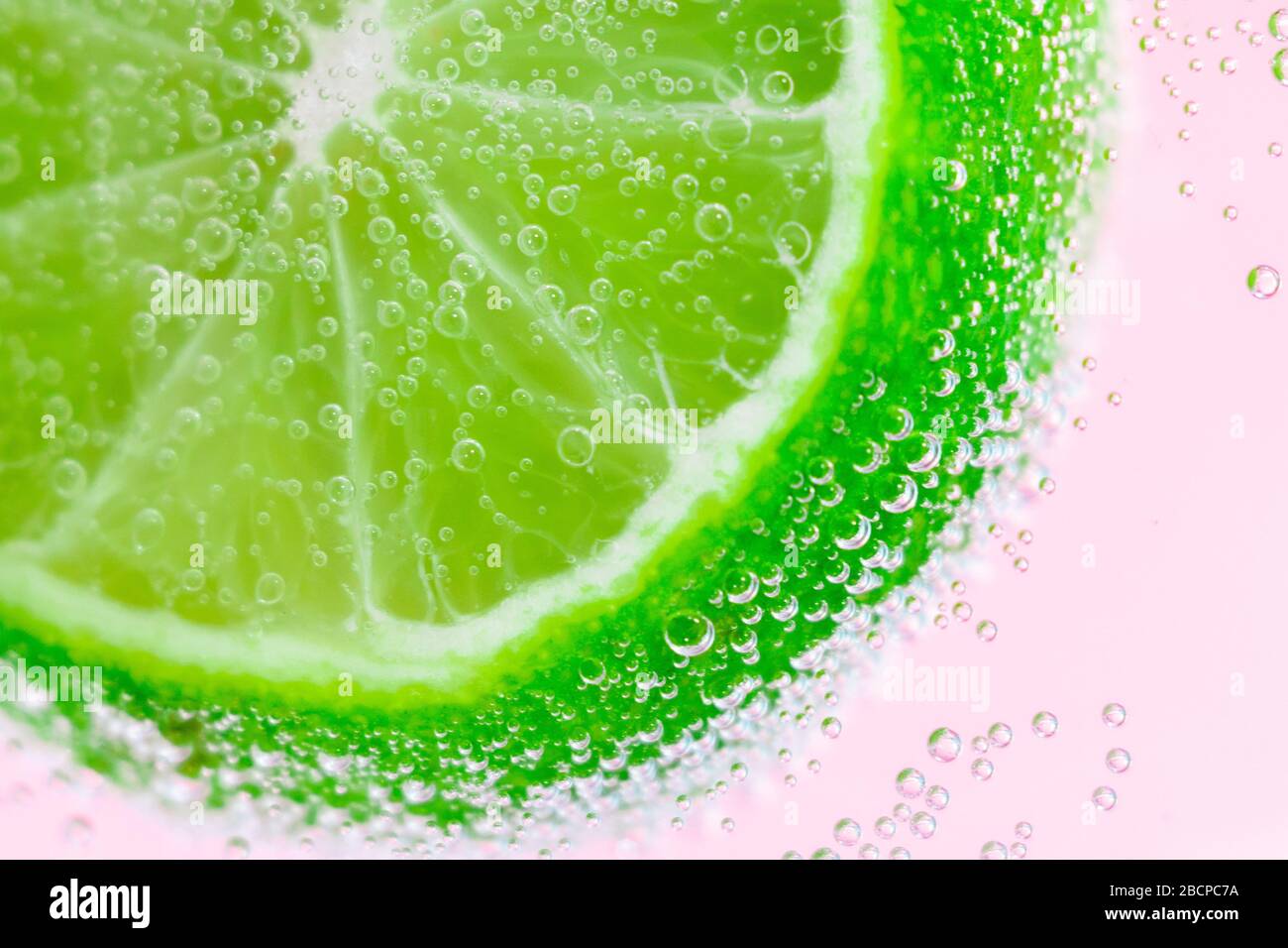 lime fruits in water under water with bubbles. juicy citrus close-up ...