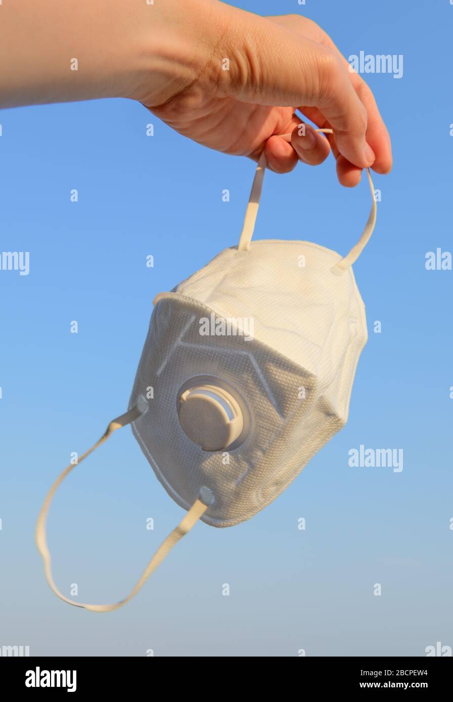 Man giving medical mask to another person Stock Photo - Alamy